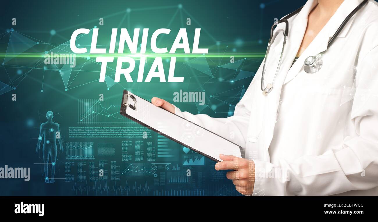 doctor writes notes on the clipboard with CLINICAL TRIAL inscription ...