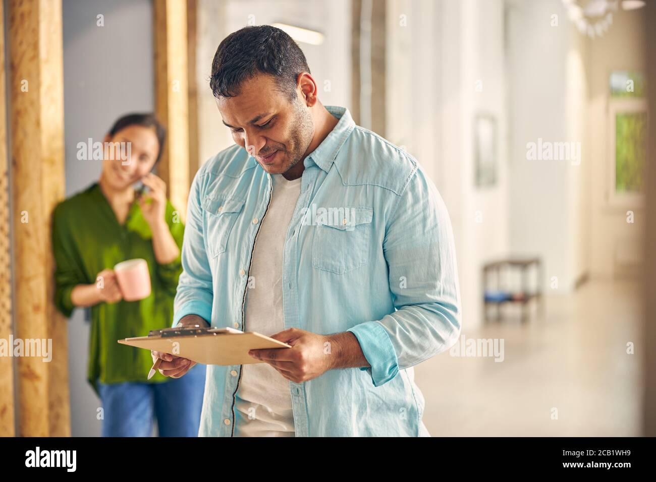 Handsome brunette man staring at his notes Stock Photo - Alamy