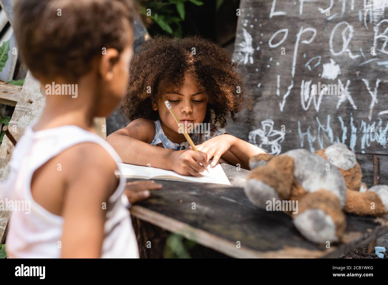 African american kids writing at a desk hi-res stock photography and ...