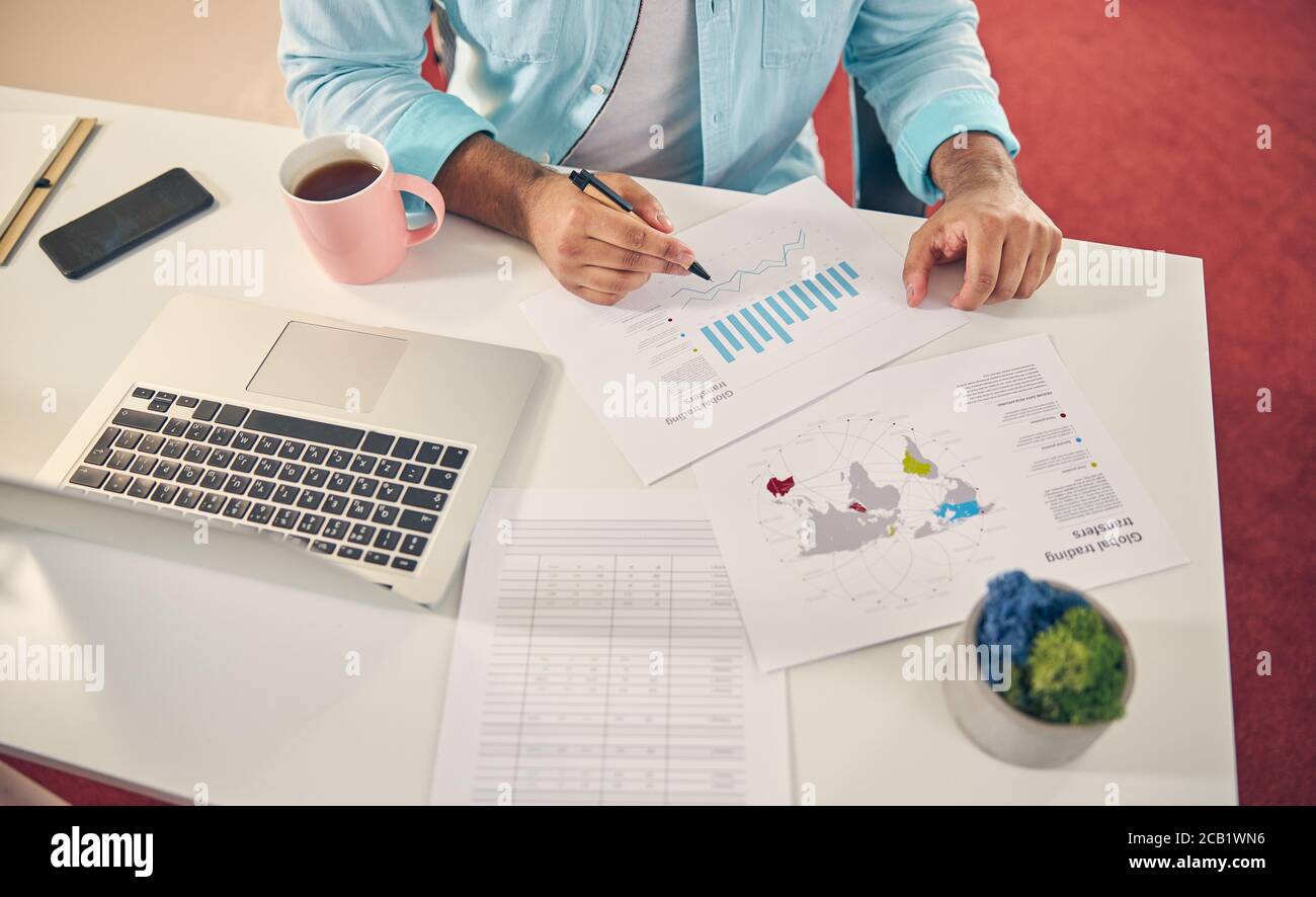 Busy male person doing analysis of working activity Stock Photo - Alamy