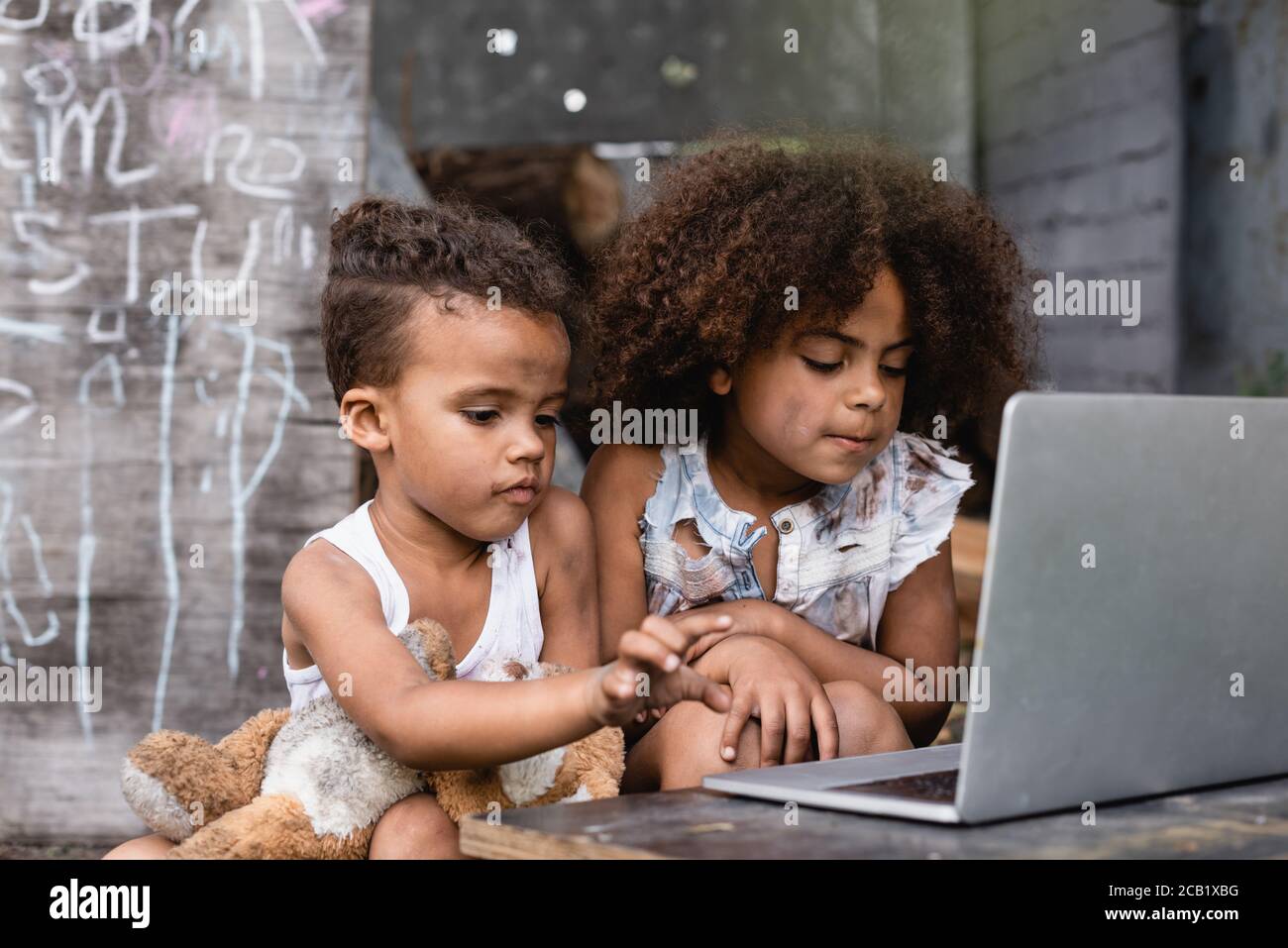 Children using laptop poor hi-res stock photography and images - Alamy