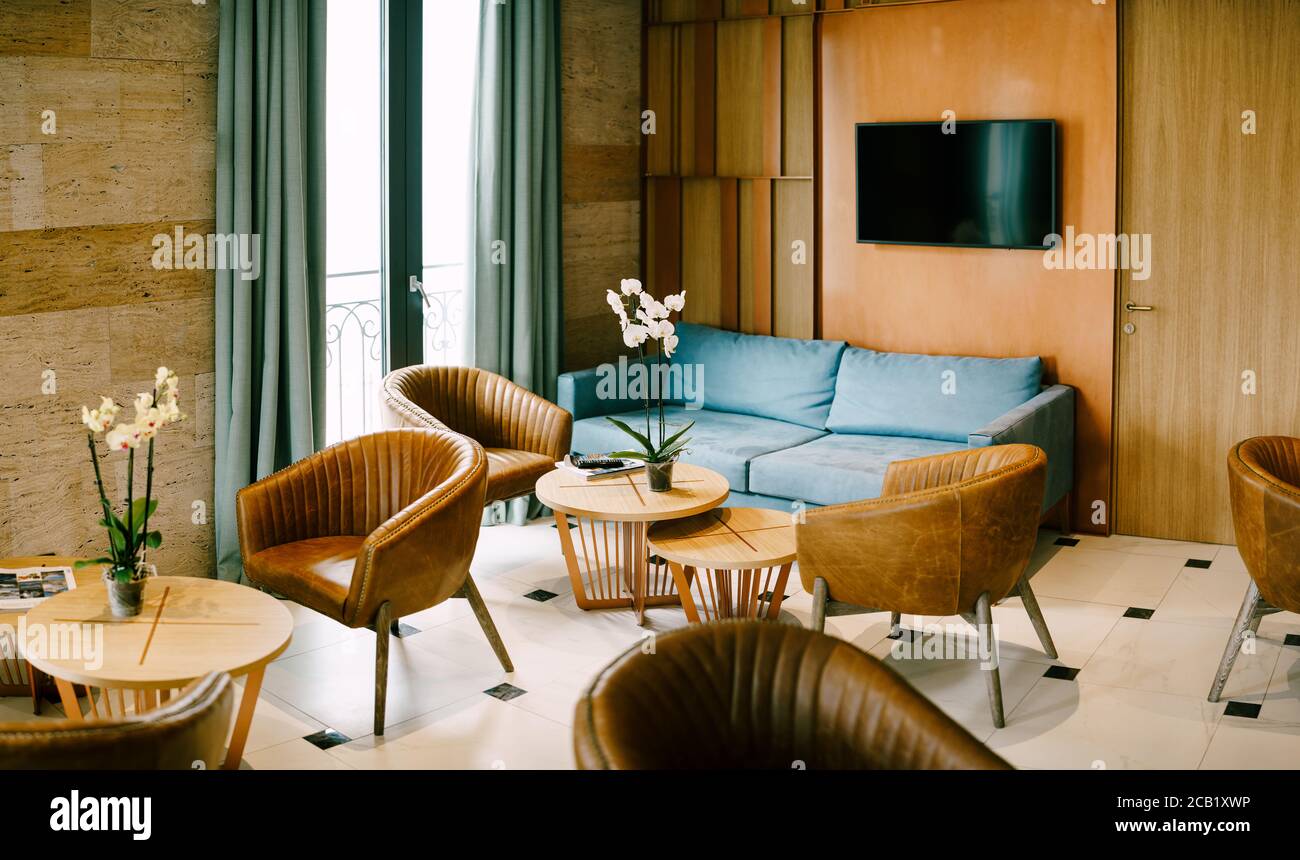 Blue sofa under the TV with access to the balcony in the hall with ...