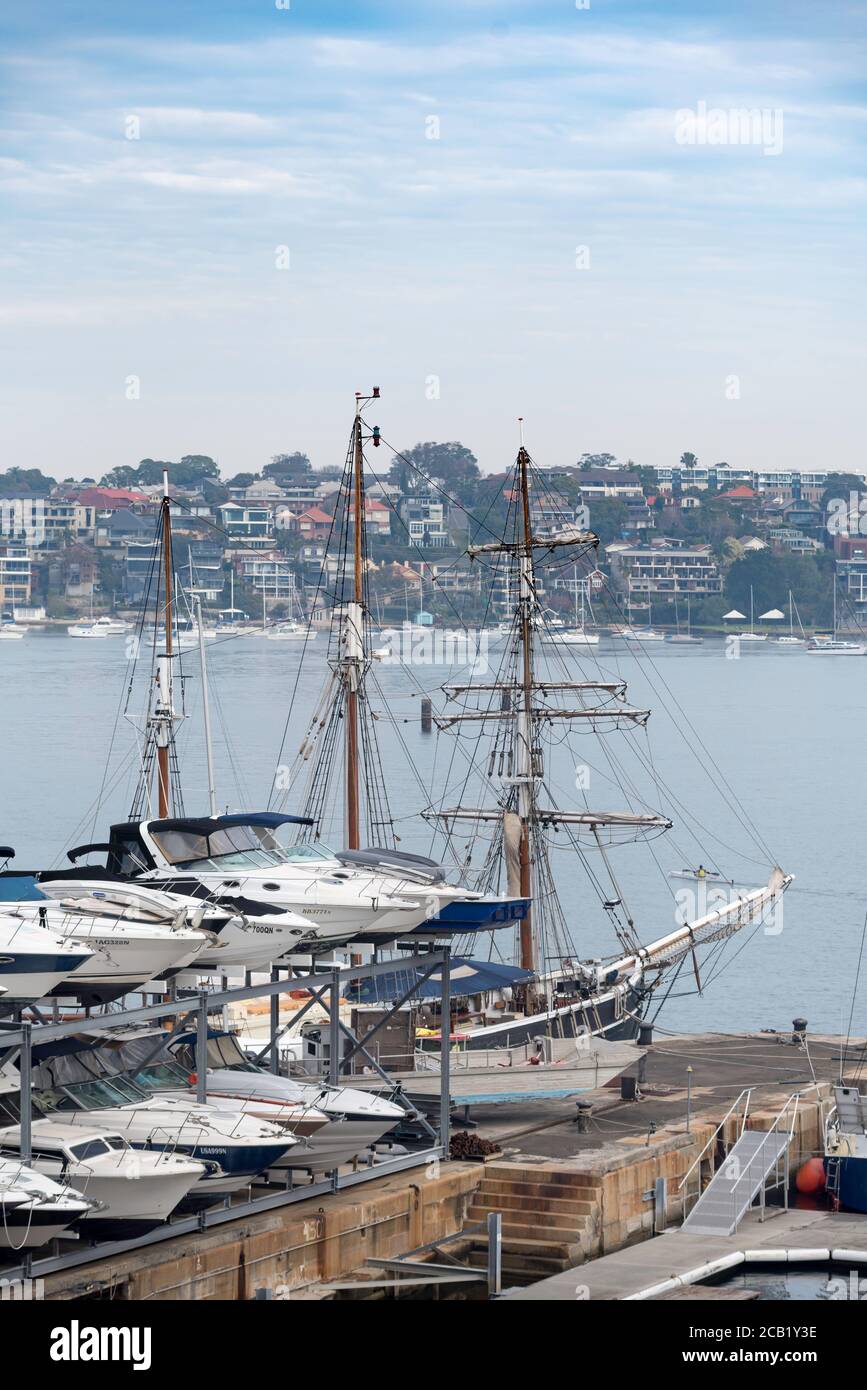 A Tall Ship is moored beside a double height storage rack full of large ...