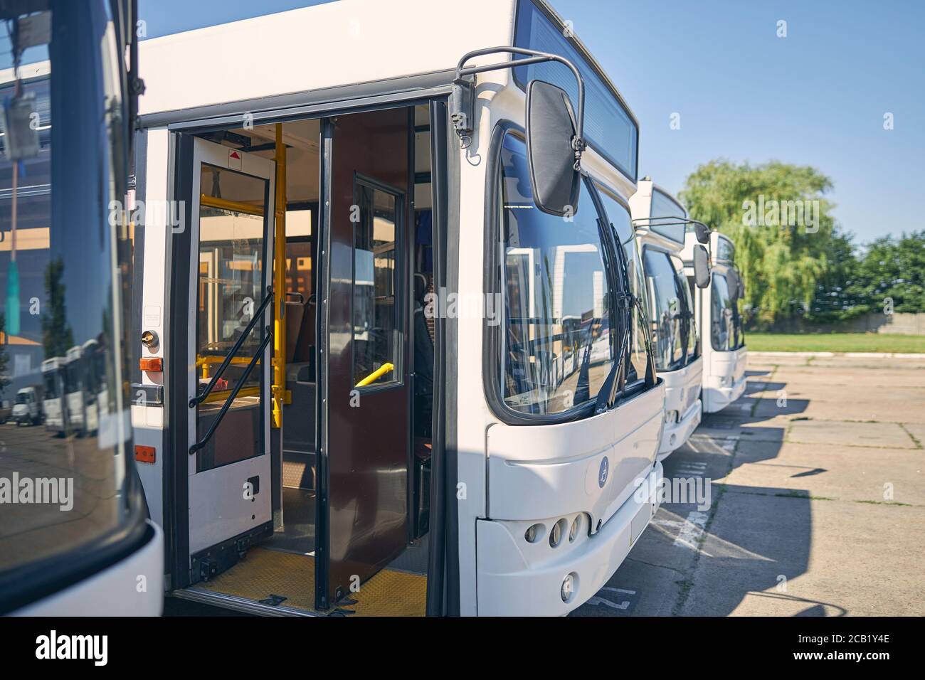 Close up of white bus with opened doors Stock Photo - Alamy