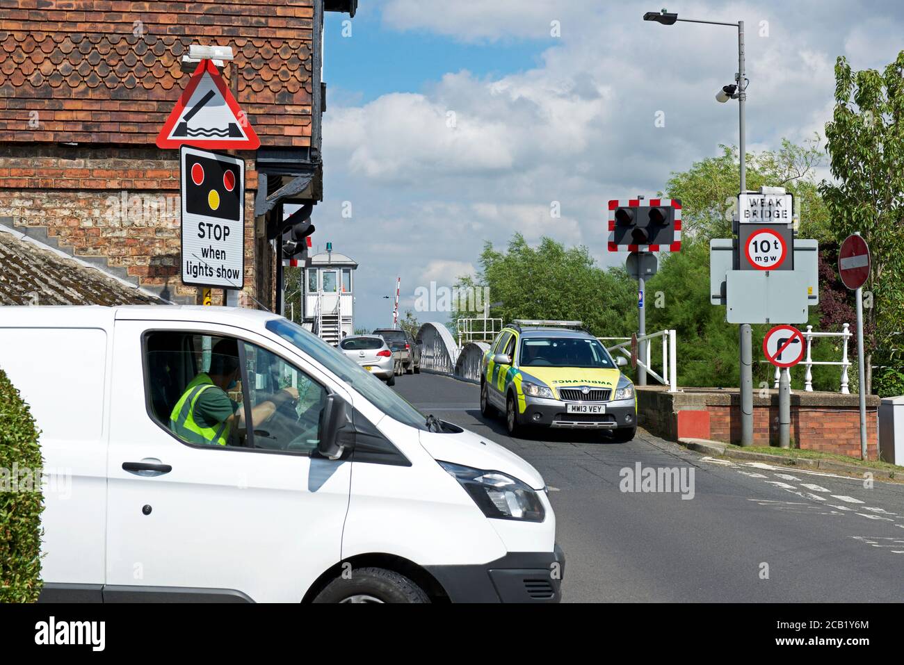 Ambulance crossing the swing bridge bridge in the village of Cawood ...