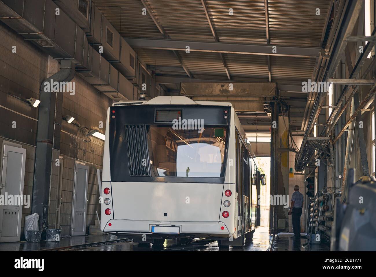 Back view of bus standing in hangar Stock Photo - Alamy