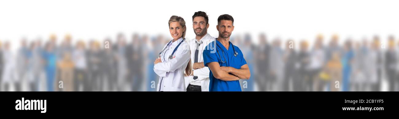 Team of three doctors standing in front of crowd of many people ...