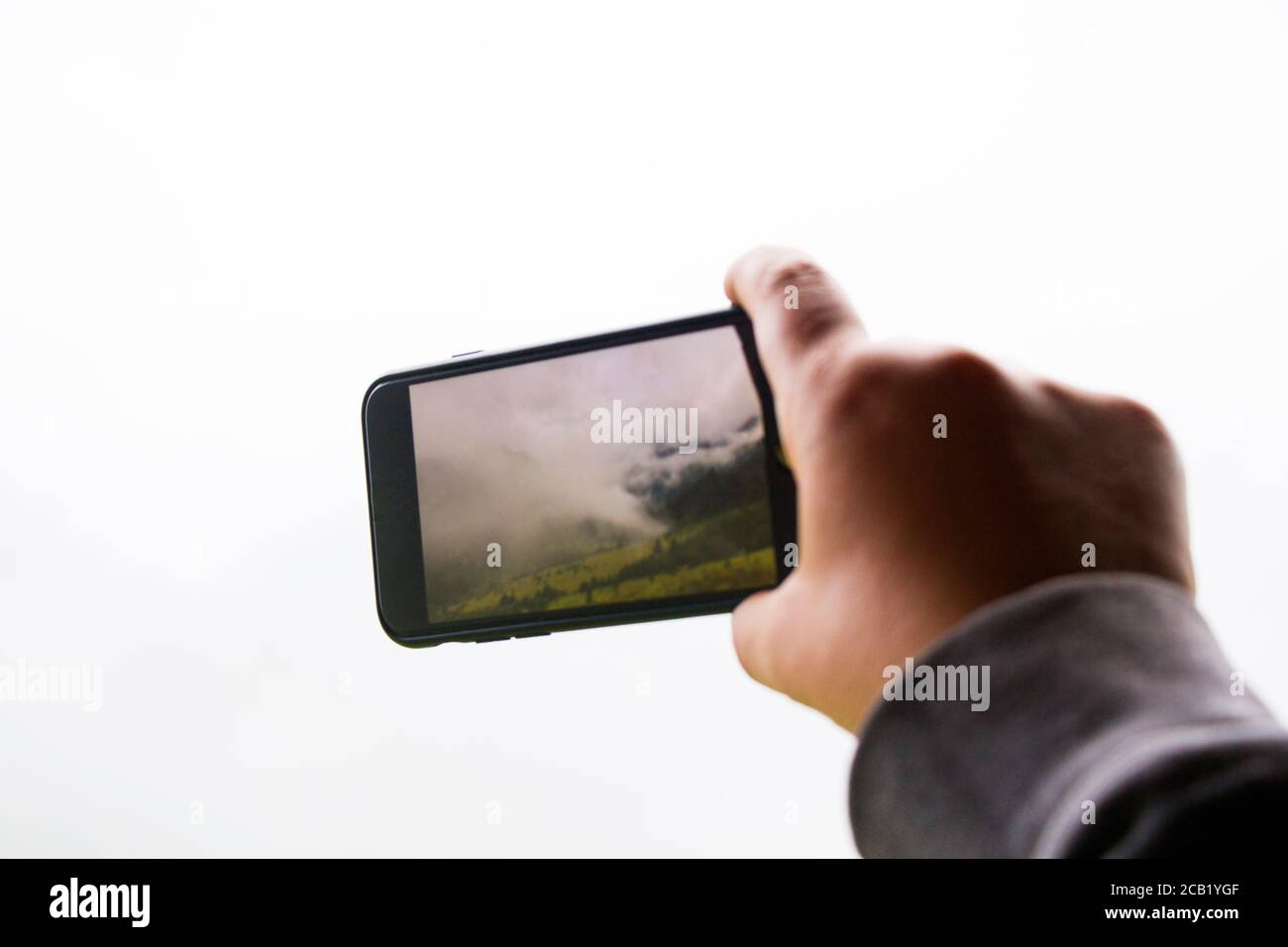 Holding smartphone and take photo and video if nature landscape ...