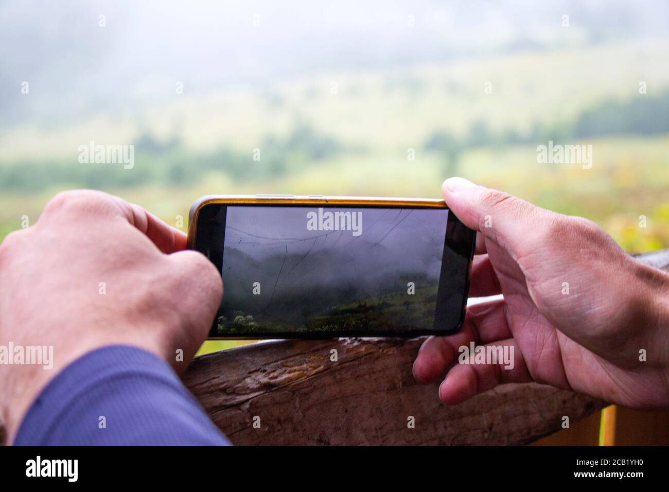 Holding smartphone and take photo and video if nature landscape ...