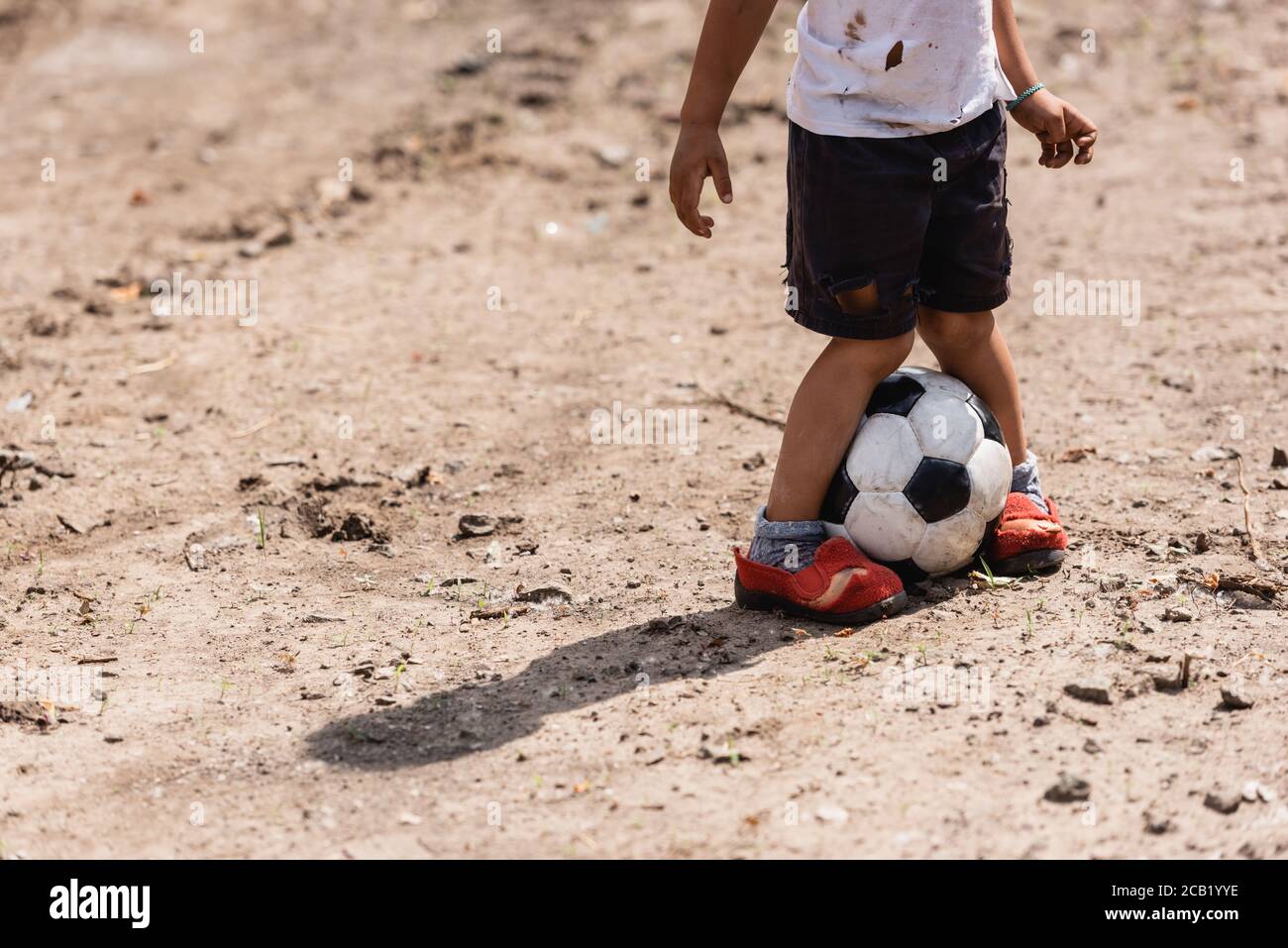 Poor child playing football hi-res stock photography and images - Alamy