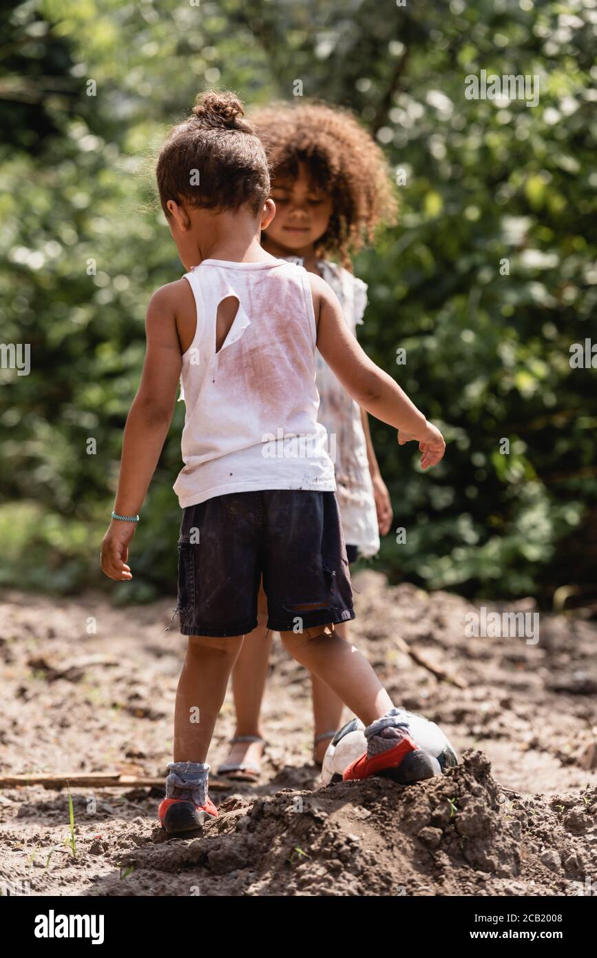 Selective focus of poor african american children in messy clothes ...