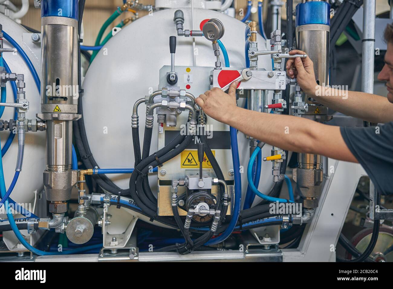 Competent mechanic doing checkup of pressure in unit Stock Photo - Alamy