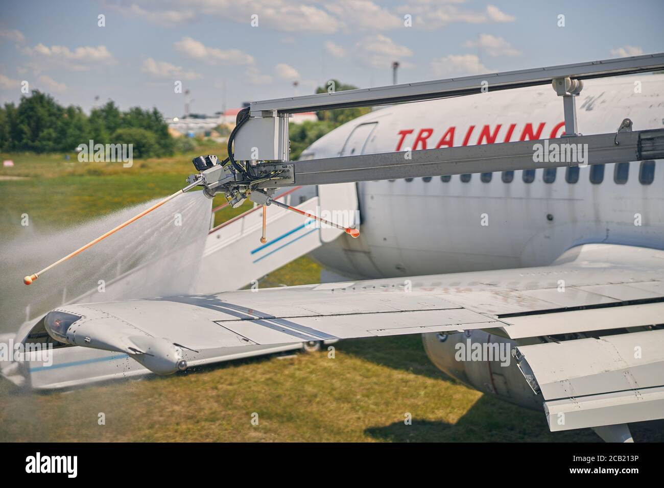 Close up of special unit washing airplane wing Stock Photo - Alamy
