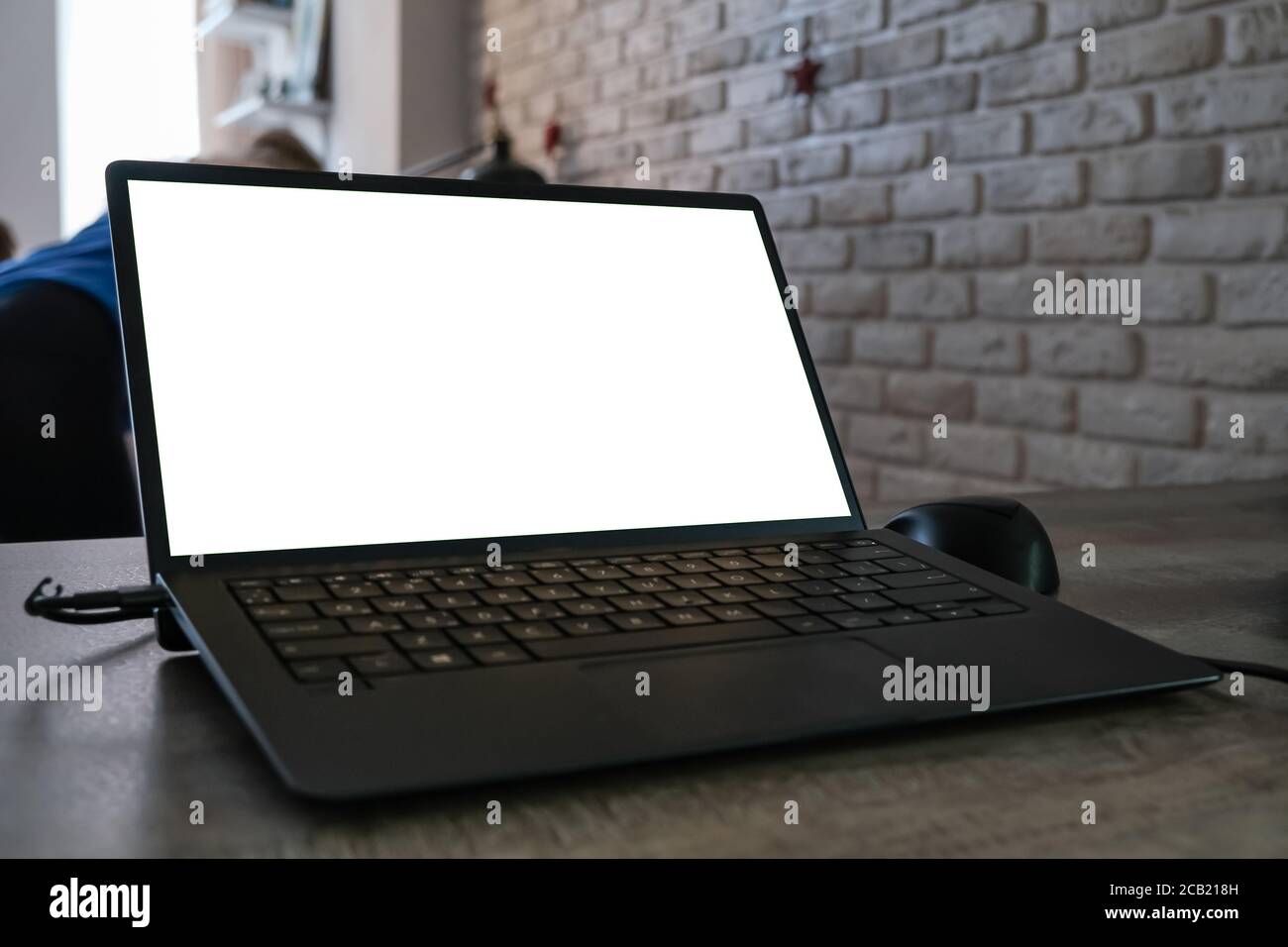 Laptop mockup with blank green screen on wooden table against white ...
