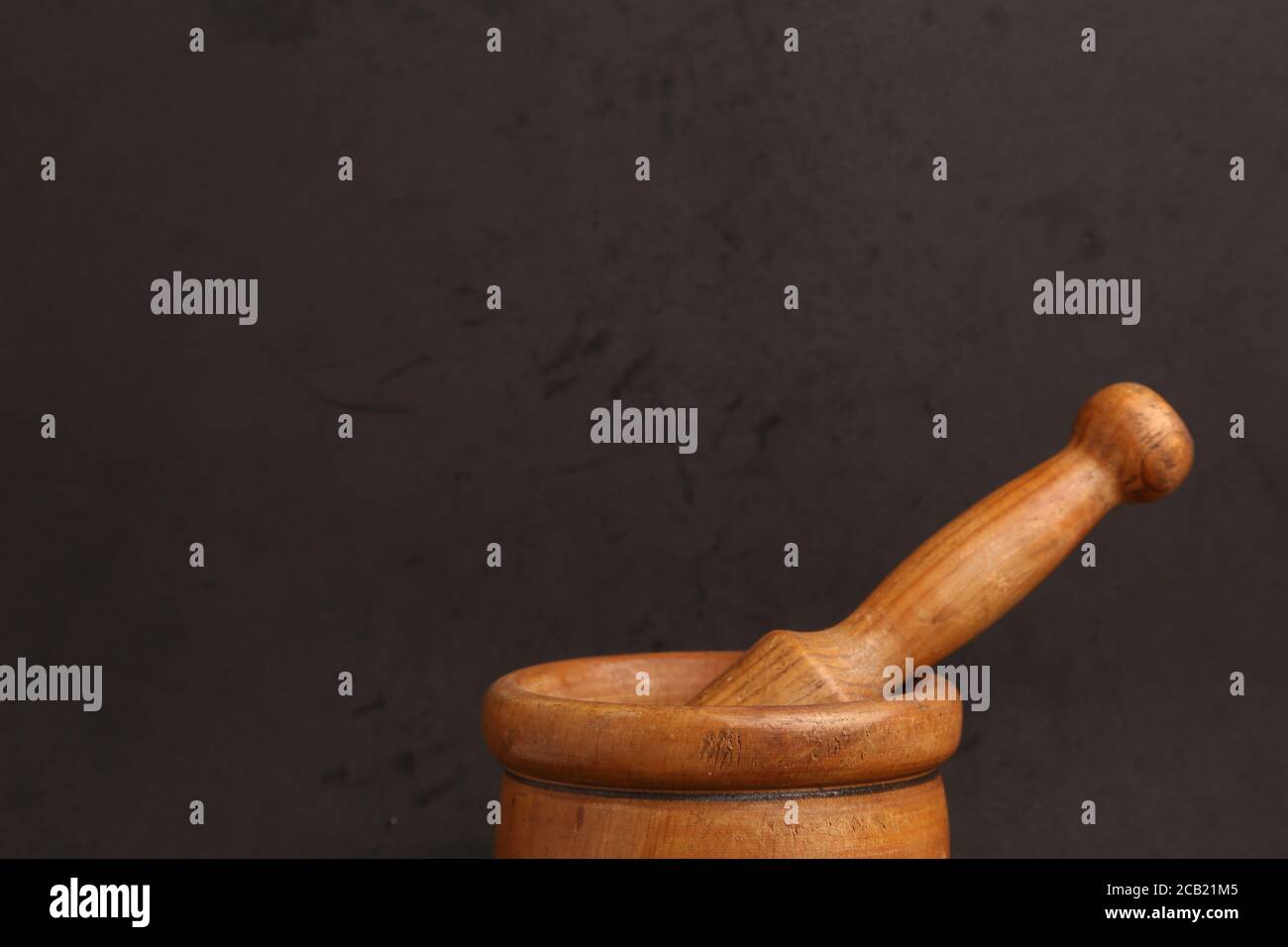 Traditional wooden mortar on the black background Stock Photo - Alamy