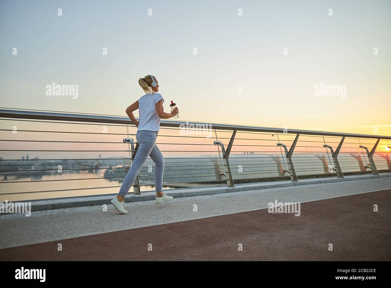 Female runner working out in the evening Stock Photo - Alamy