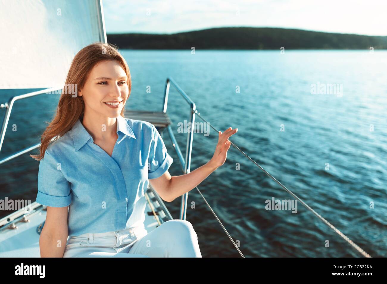 Pretty Woman Sitting On Yacht Deck Enjoying Sailboat Ride Outdoors ...