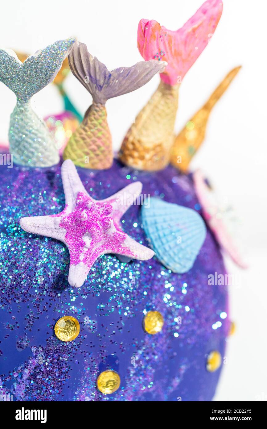 Halloween craft pumpkins decorated with mermaid tails, glitter, and ...