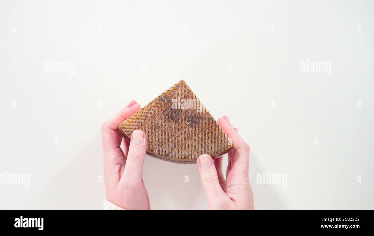 Flat lay. Large slice of gourmet cheese on a white background Stock ...