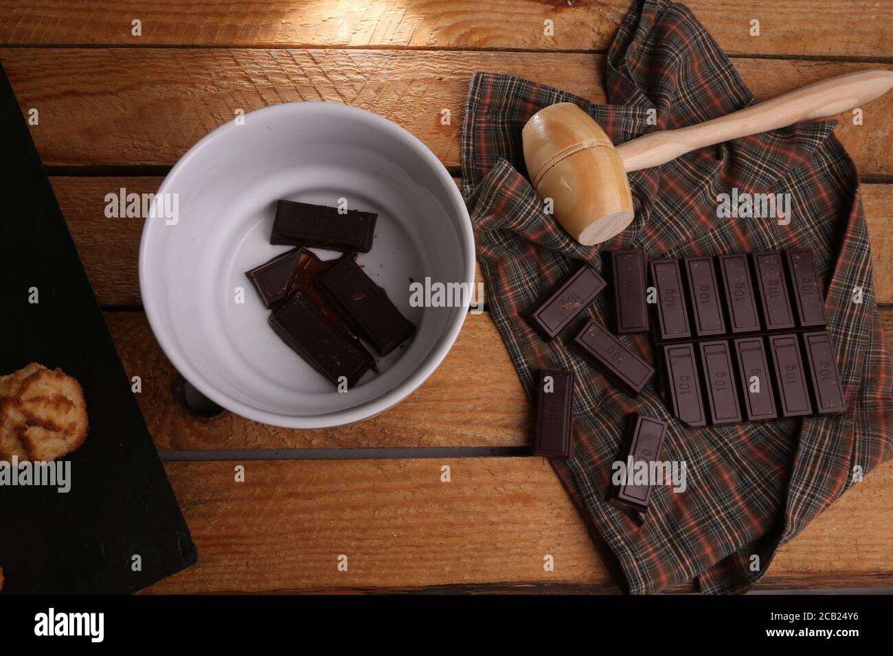 Top view of a bar of dark chocolate on a checkered cloth next to a ...