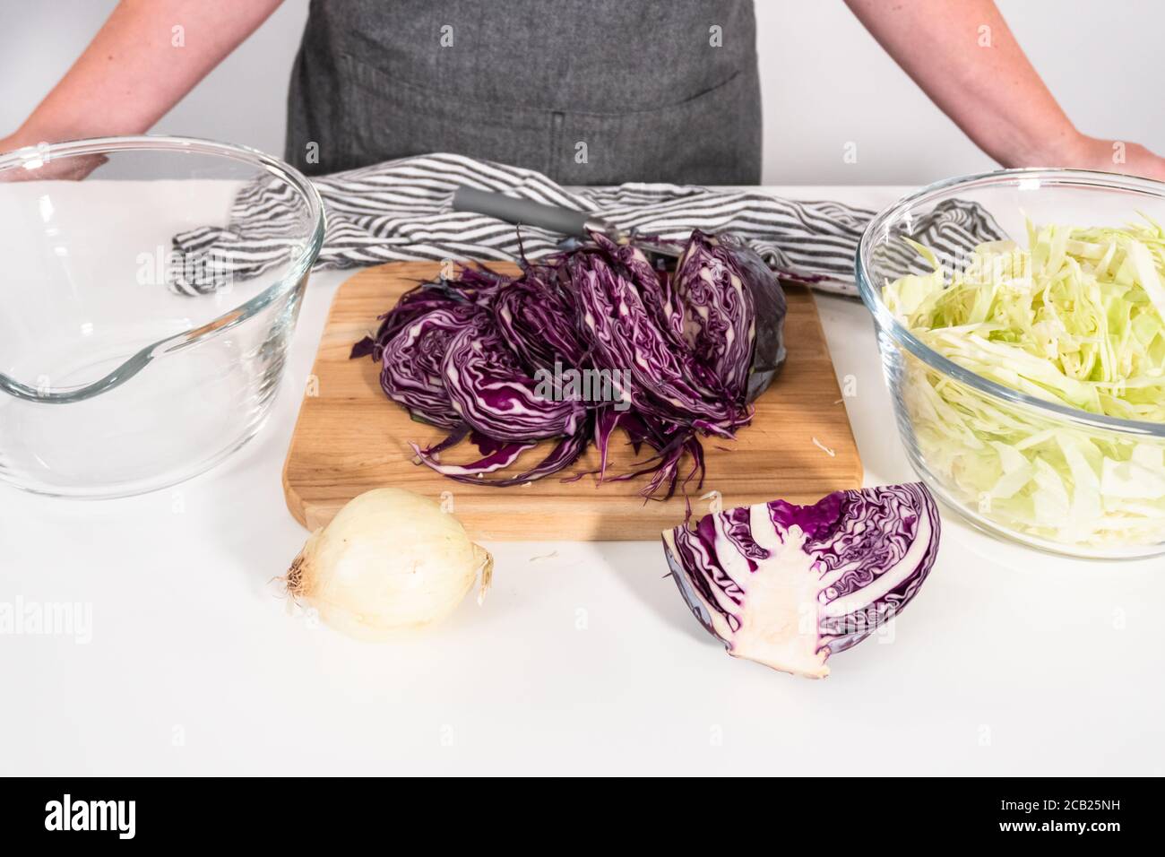 Shredding red cabbage on a wood cutting board Stock Photo - Alamy