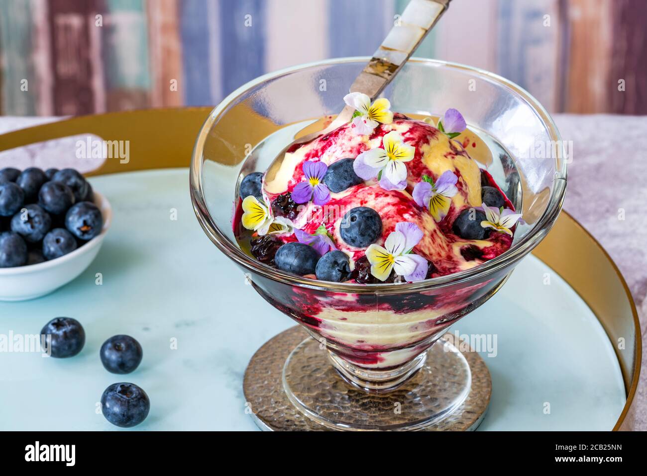 Ice cream dessert with blueberry and cardamom compote garnished with ...