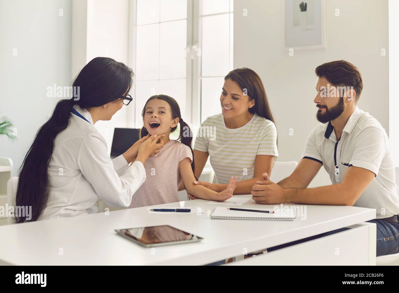 Family doctor. Woman doctor checks the health of the child with the ...