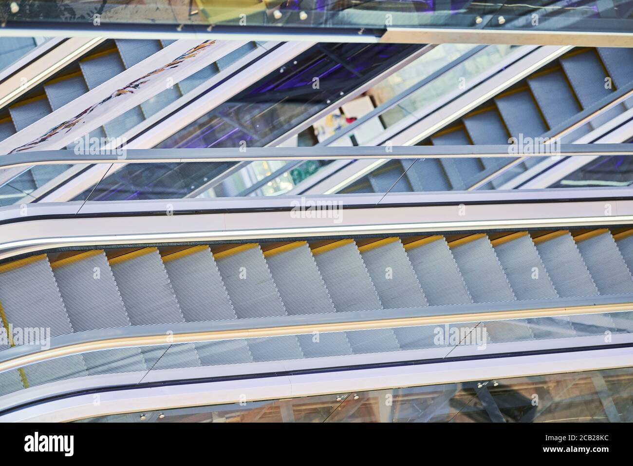 Escalators in shopping center. Empty moving staircase up and down in office building, shopping ...