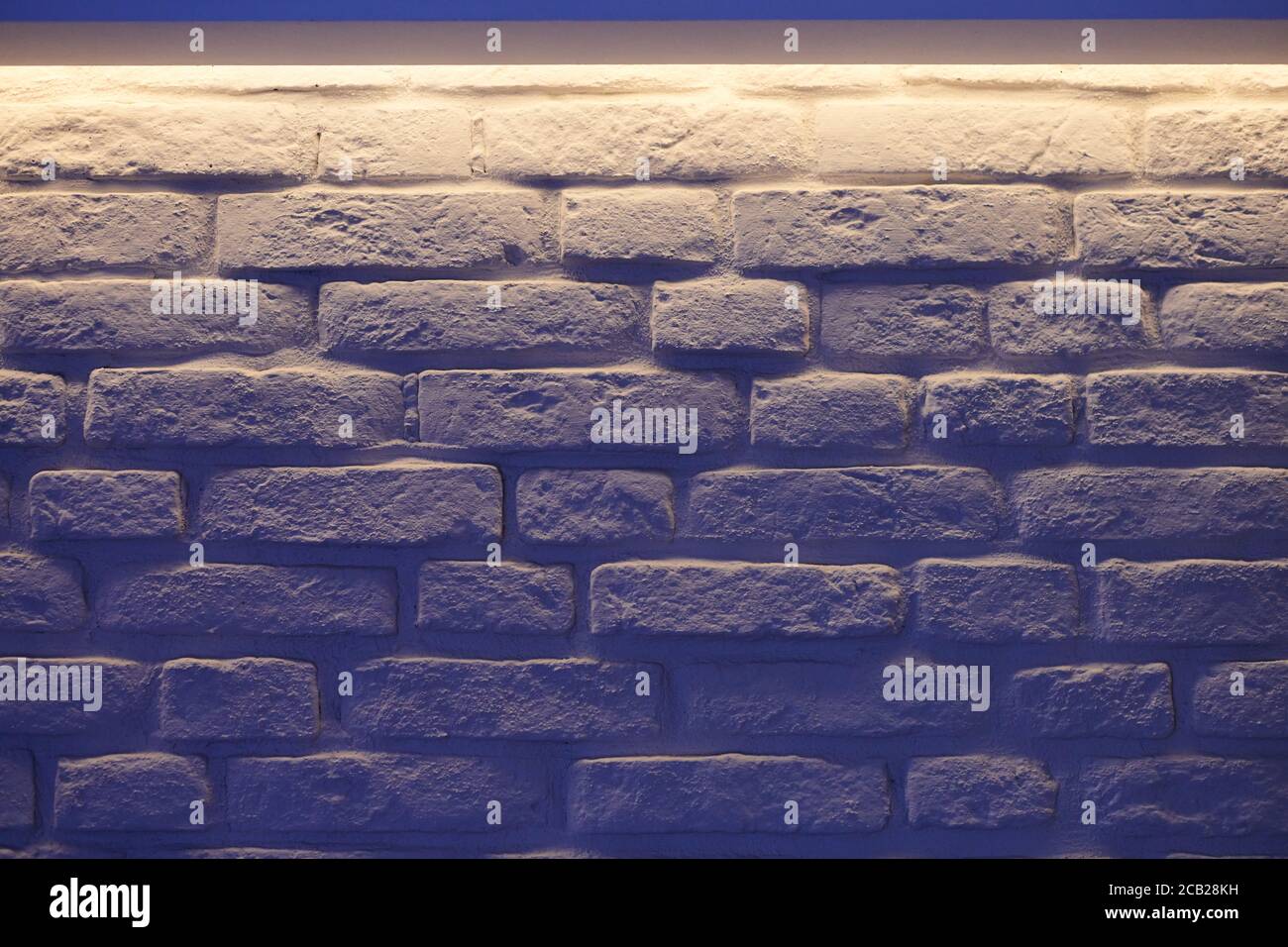 Brick wall indigo lighting. White wall blue glow in modern vintage loft ...