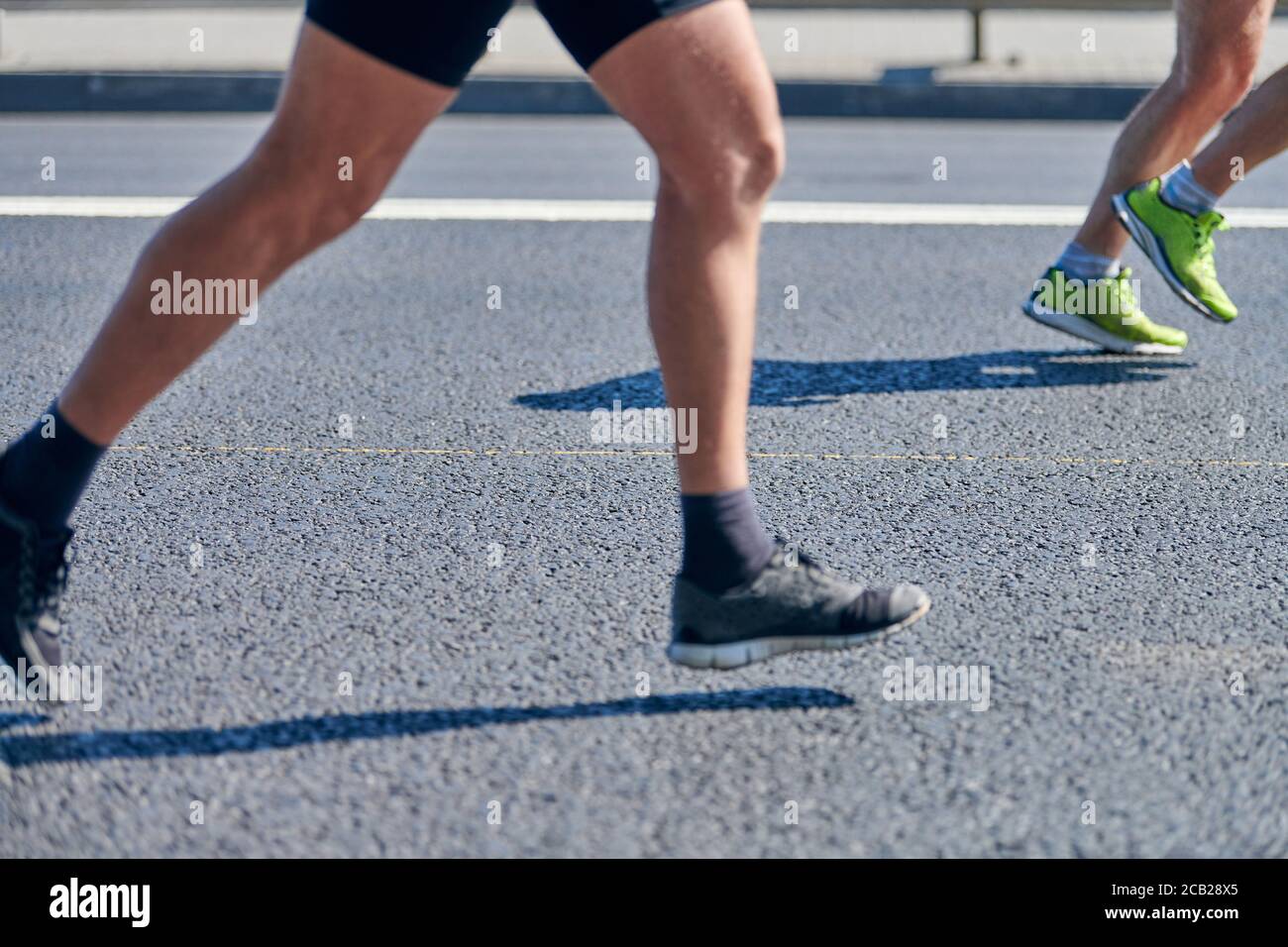Running man. Athletic man jogging in sportswear on city road. Healthy lifestyle, fitness sport ...