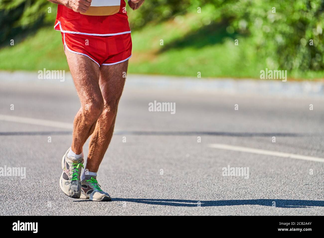 Running old man. Old man jogging in sportswear on city road. Healthy ...
