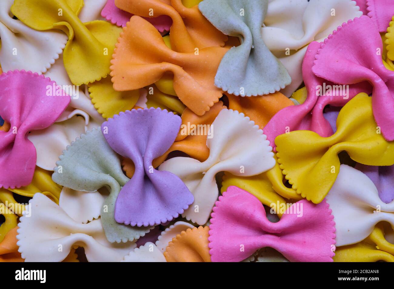 Colorful Italian raw pasta Farfalle Uncooked pasta as background Stock ...
