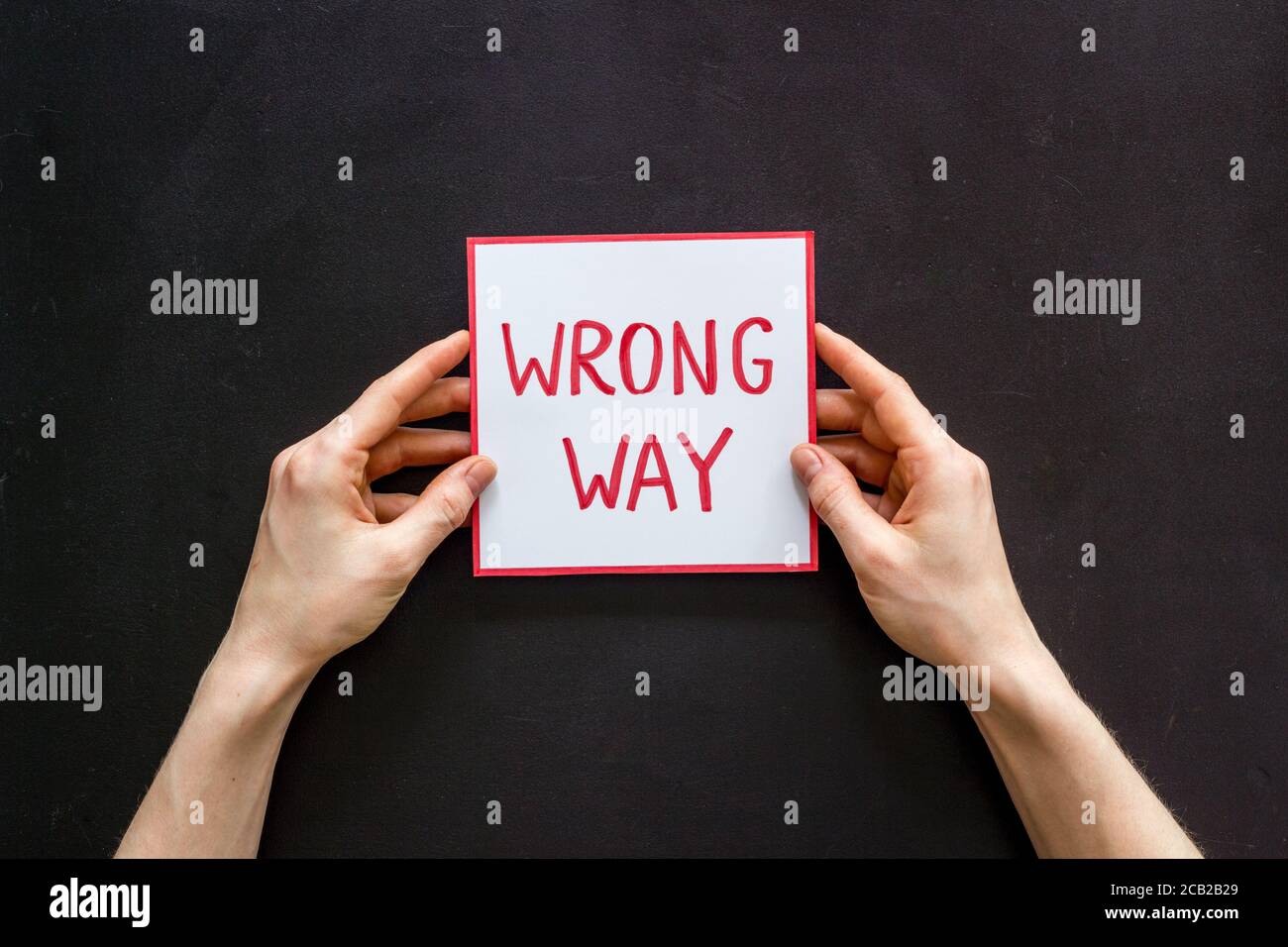 Business failure. Wrong way icon in hands on office desk top-down Stock ...