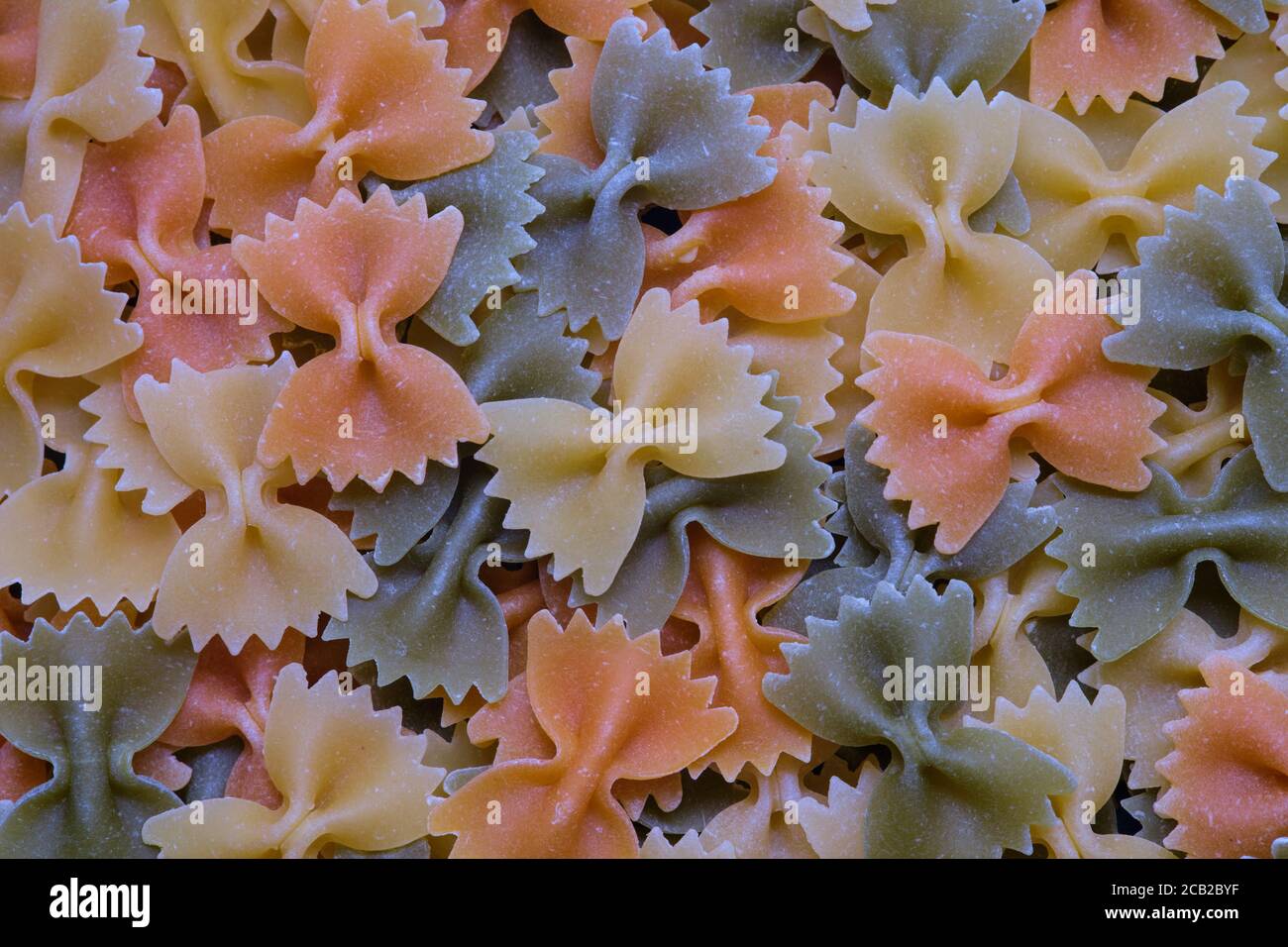 Colorful Italian raw pasta Farfalle Uncooked pasta as background Stock ...