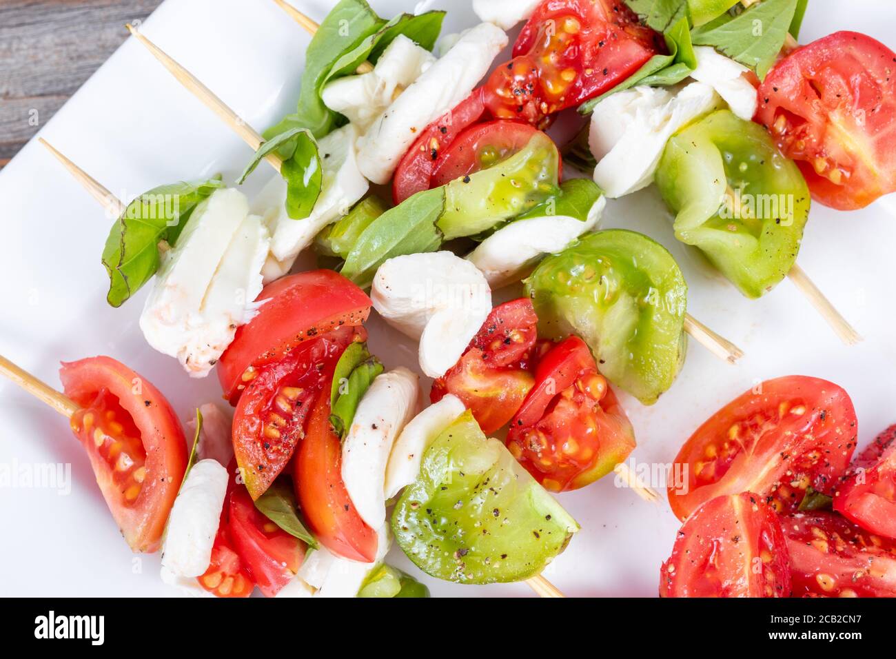 tomato basil and mozzarella cheese antipasti on a stick plate closeup ...