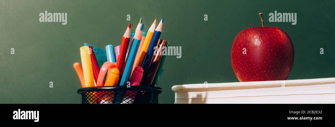 website header of pen holder with color pencils and pens, and ripe ...