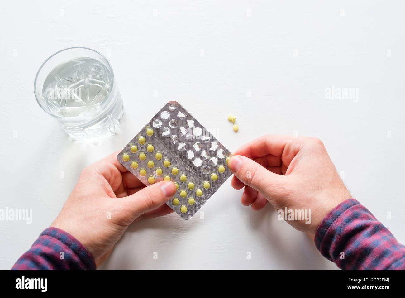 a man takes a sedative on a white background Stock Photo - Alamy