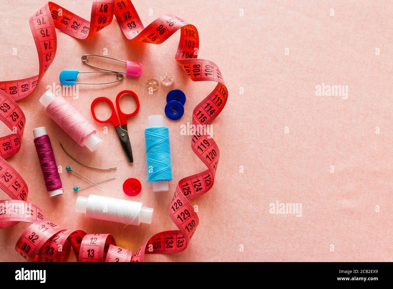 Scissors measuring tape and threads on table hi-res stock photography ...