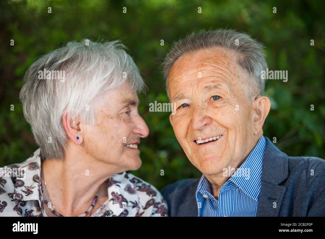 Head-and-shoulder portrait of an 80 year old pensioner couple against ...
