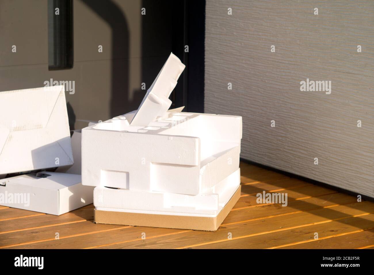 styrofoam package and cardboard boxes abandoned outside the house Stock ...