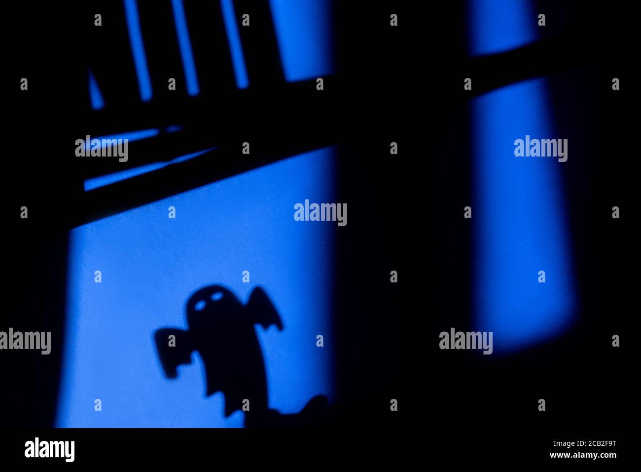 Halloween ghost on blue, window shadow. Copy space, festive concept ...