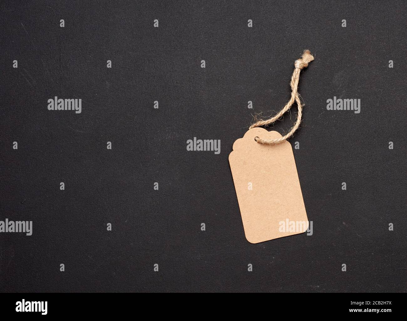 empty paper brown rectangular price tag on a rope on a black background, copy space Stock Photo ...