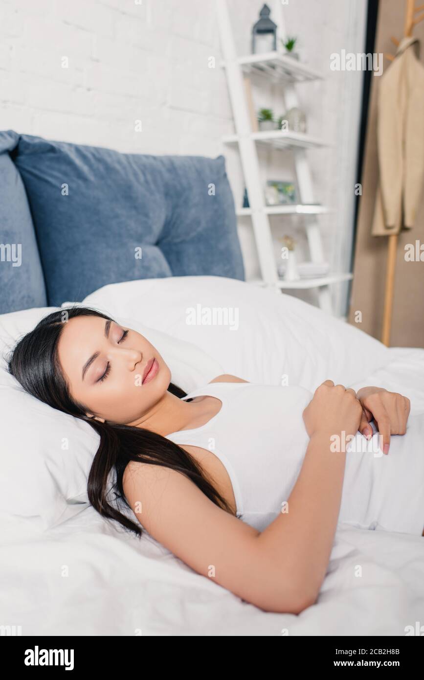 Beautiful asian woman sleeping on bed at morning Stock Photo - Alamy