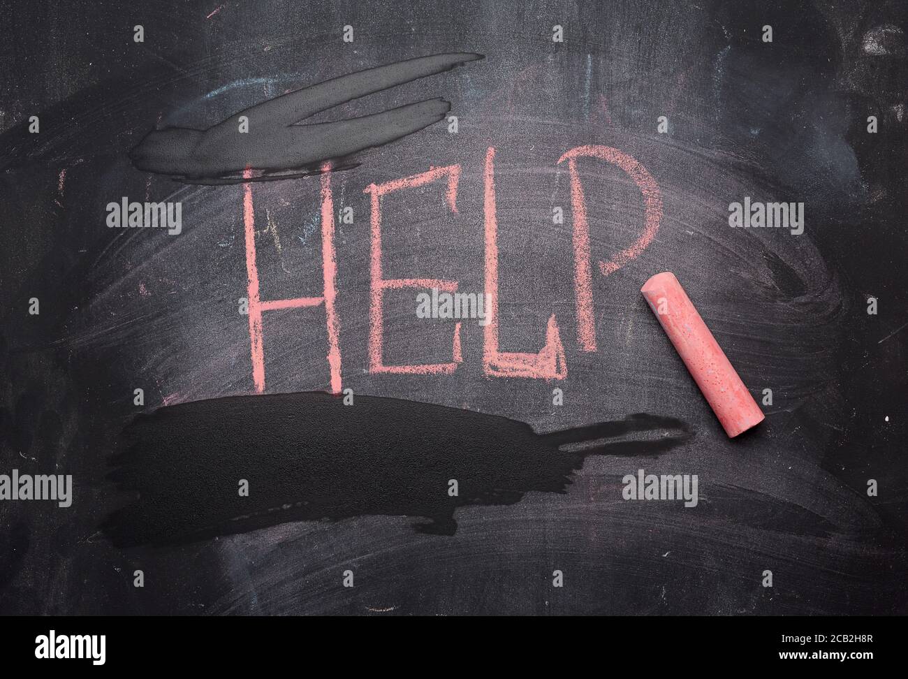 inscription help in red chalk on a black chalk board, close up Stock ...
