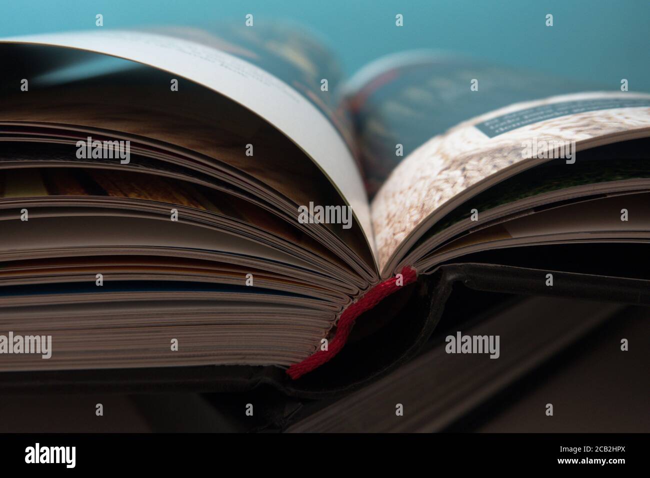 A closeup shot of an open book with photos, texture for background or ...