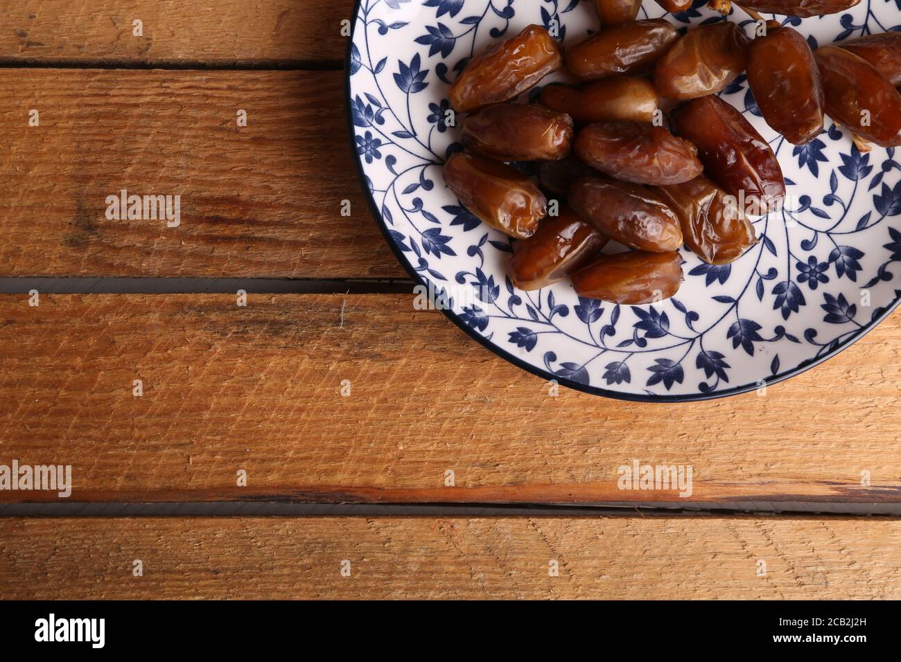 Delicious and sweet dried date palm fruits on the plate Stock Photo - Alamy