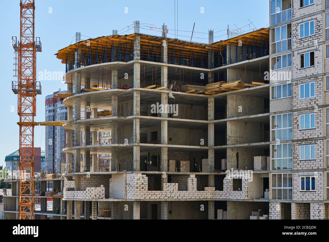 Scaffolding on construction site. Incomplete building and decoration ...