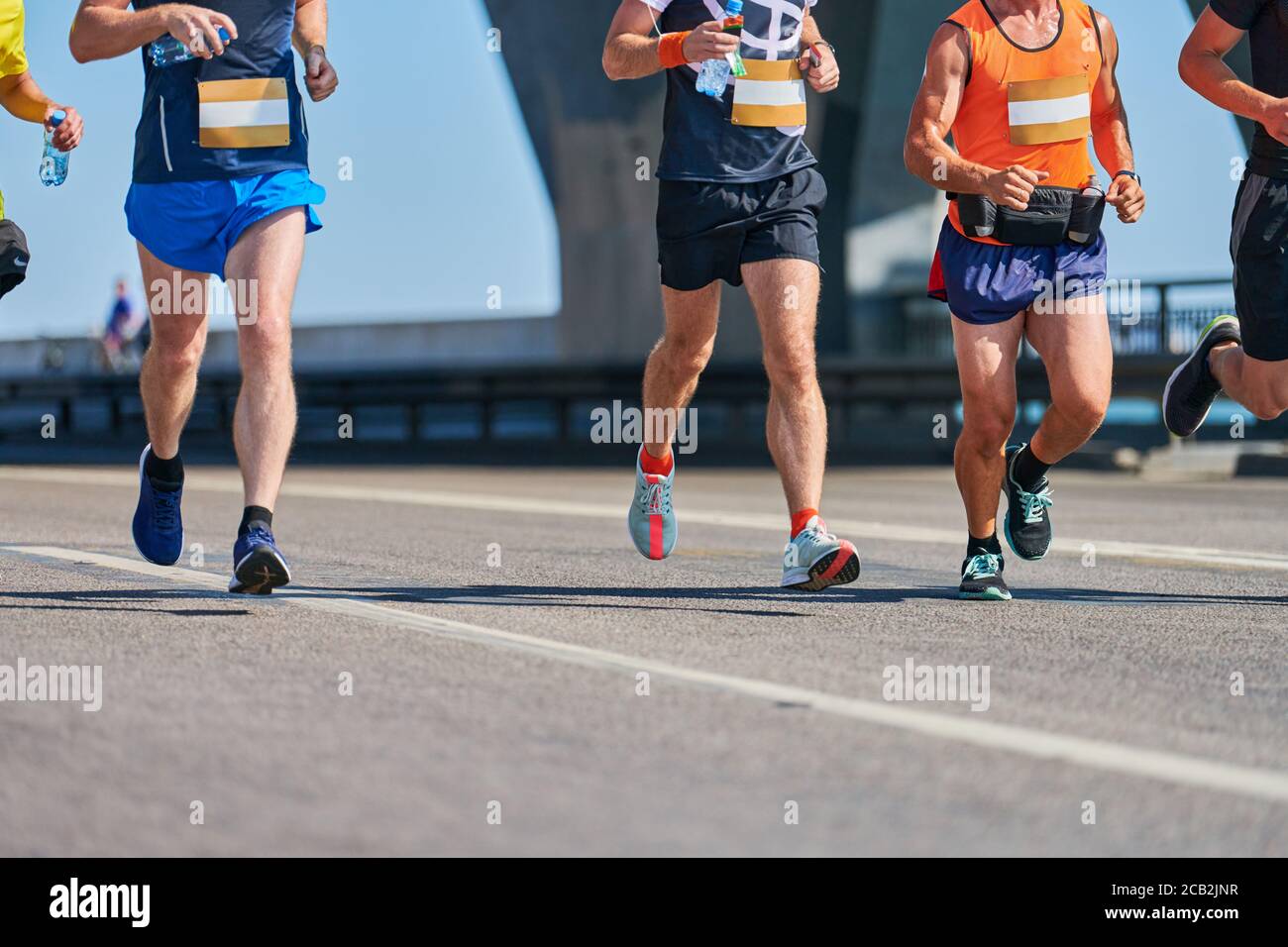 Marathon runners on city road. Running competition. Street sprinting ...