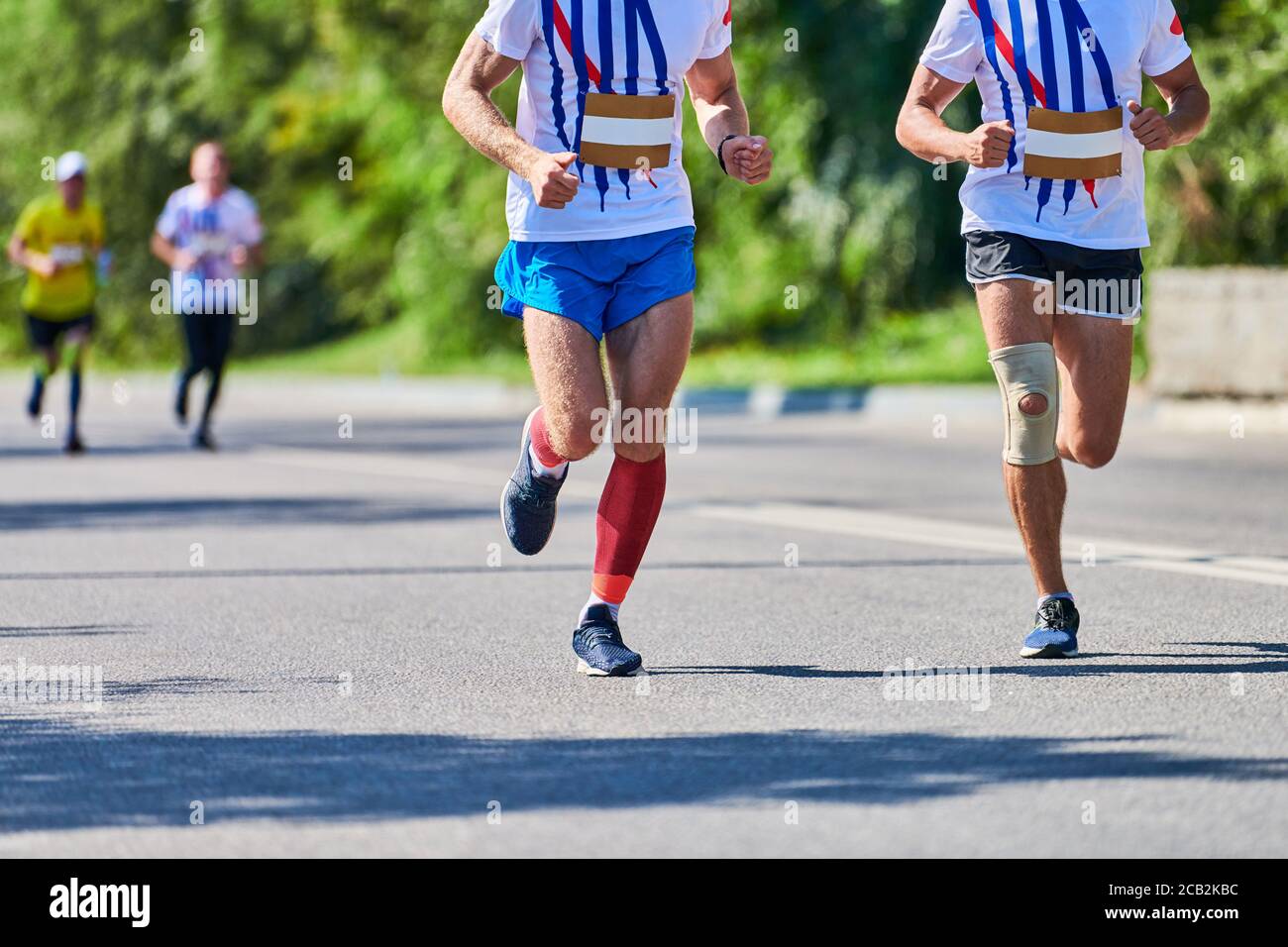 Marathon runners on city road. Running competition. Street sprinting ...