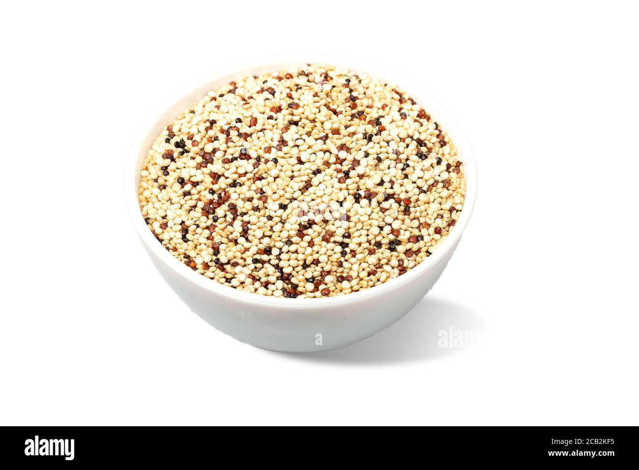Bowl full of quinoa grains isolated on white background Stock Photo - Alamy
